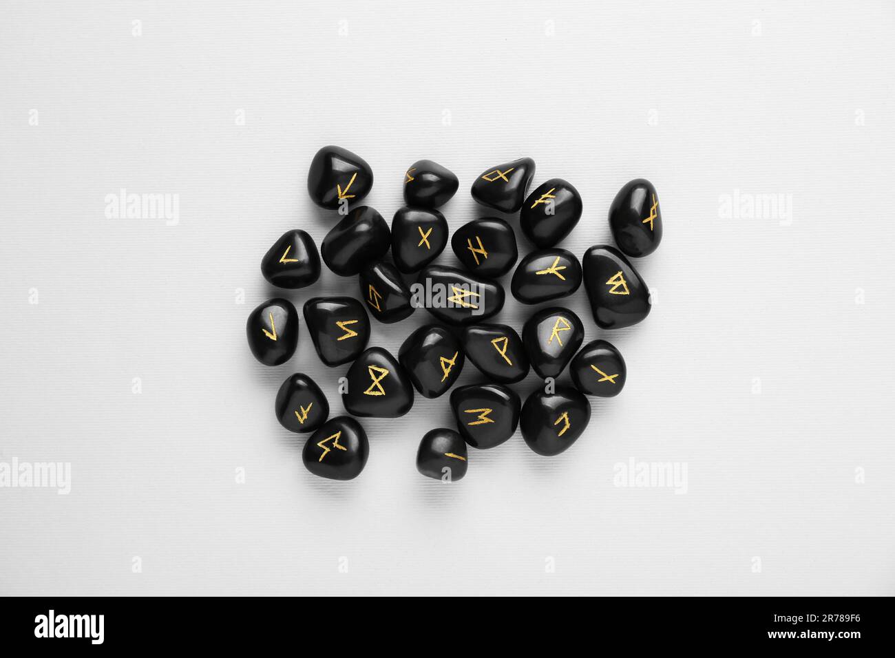 Black rune stones on white background, top view Stock Photo - Alamy
