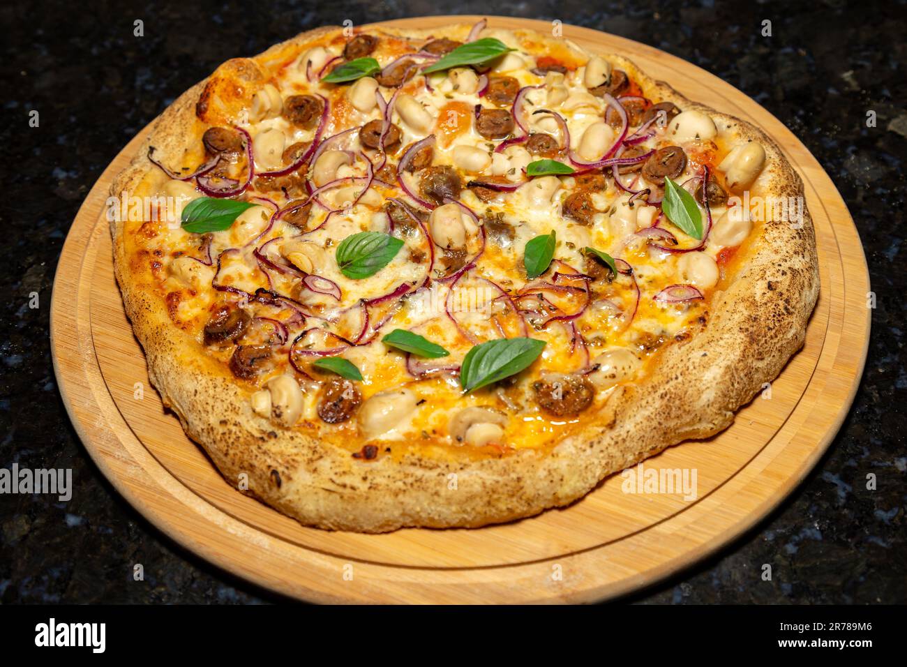 Traditional and exotic chicken heart pizza with mushrooms and onions ...