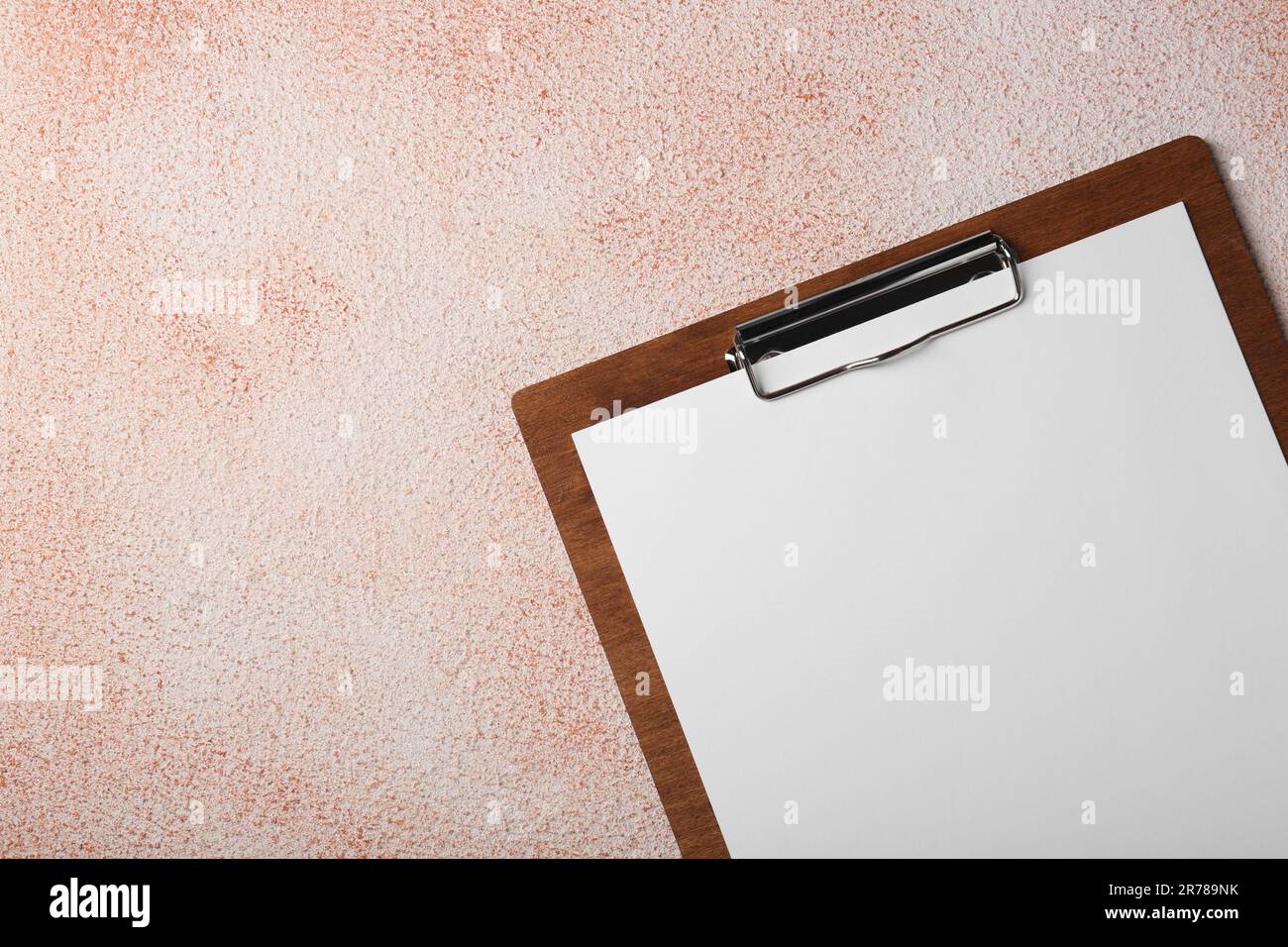 New clipboard with sheet of blank paper on color textured table, top ...