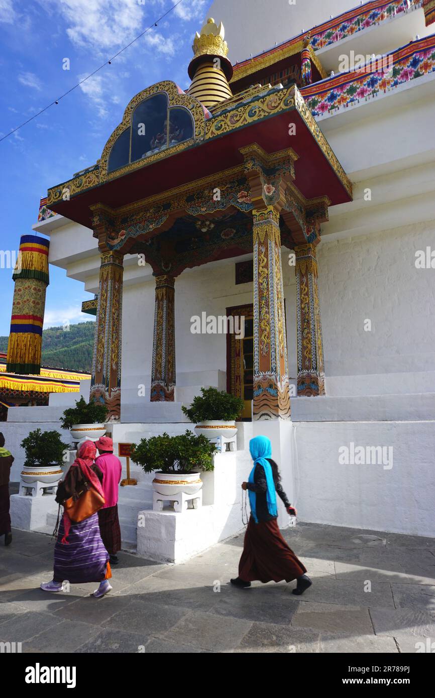 Buddhist devotees, carrying strings of prayer beads, recite prayers as ...
