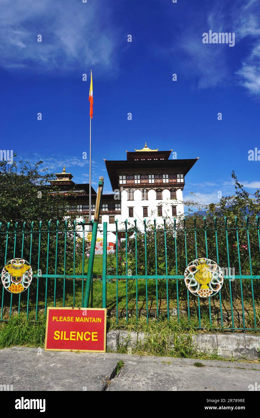 Sign requesting ‘silence’ rests against a fence in front of Tashichho ...