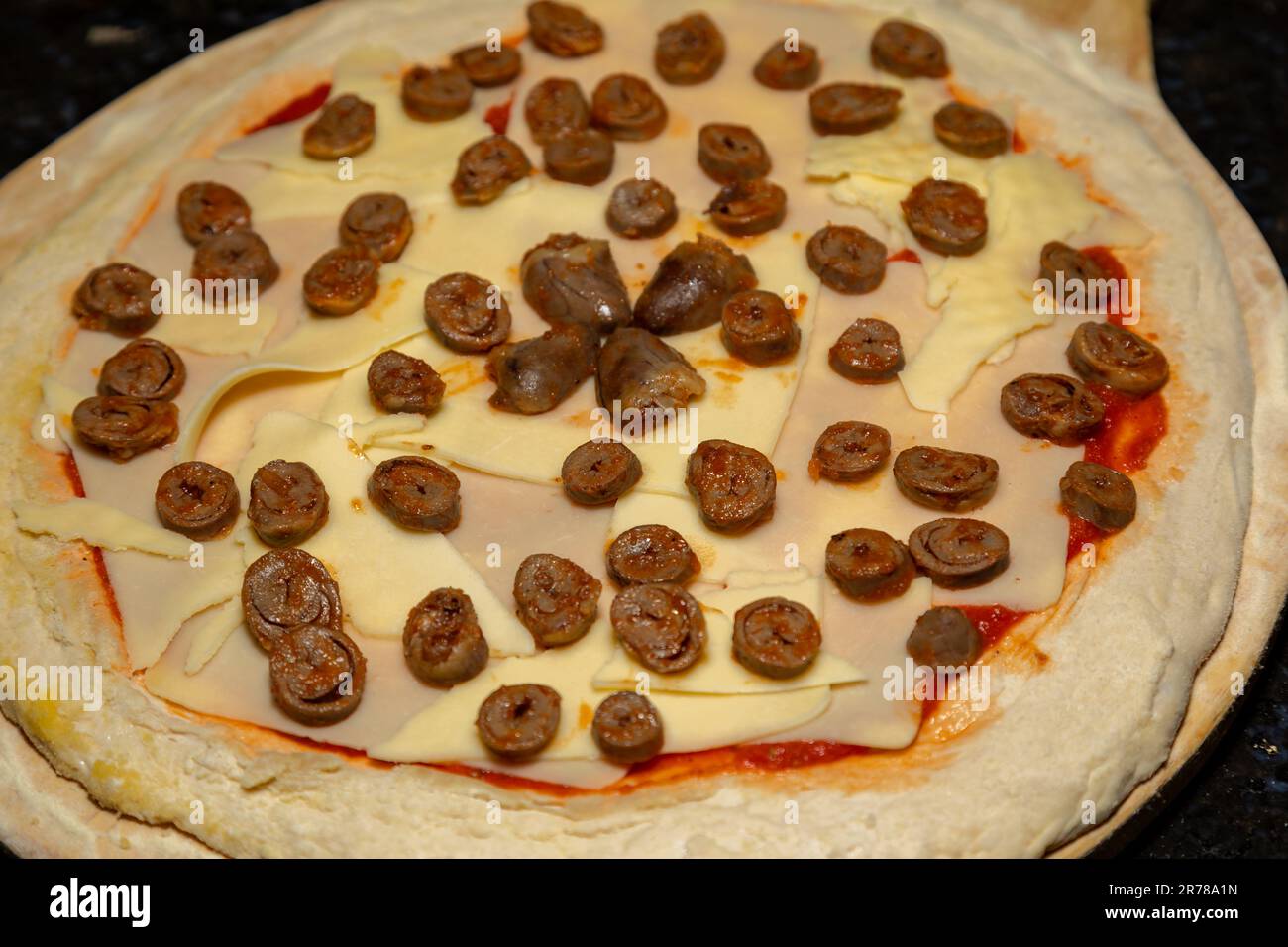 Traditional and exotic chicken heart pizza with mushrooms and onions ...