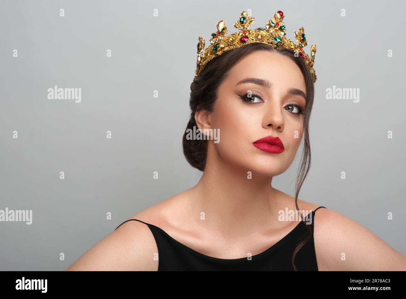 Beautiful young woman wearing luxurious crown on light grey background, space for text Stock ...