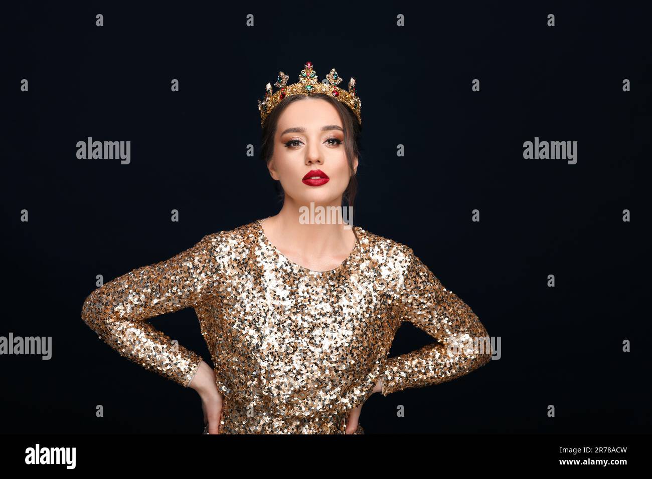 Beautiful young woman wearing luxurious crown on black background Stock Photo - Alamy