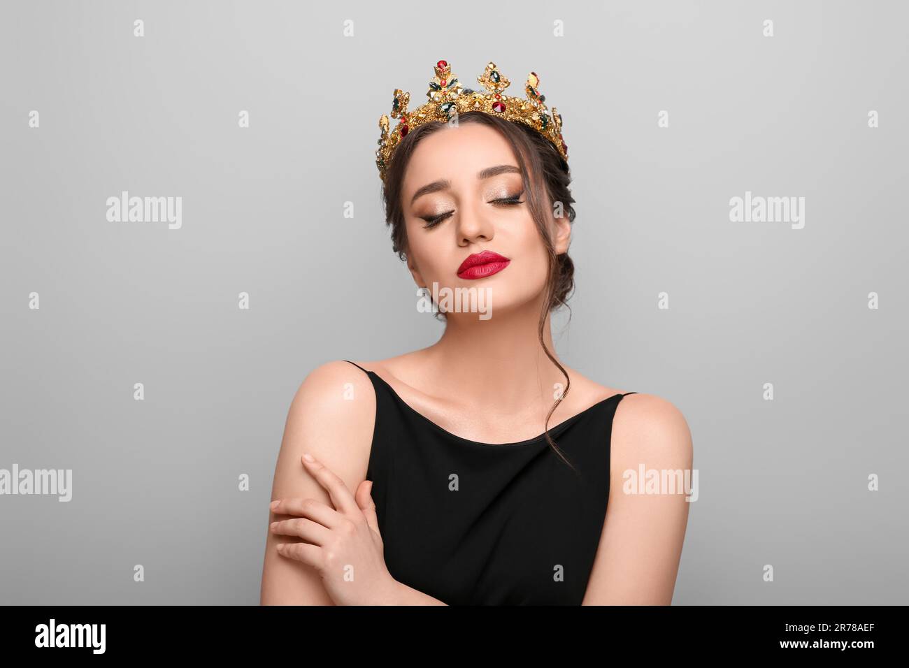 Beautiful young woman wearing luxurious crown on light grey background Stock Photo - Alamy