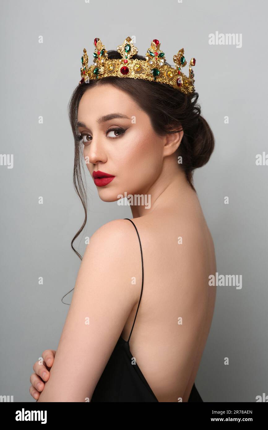 Beautiful young woman wearing luxurious crown on light grey background Stock Photo - Alamy