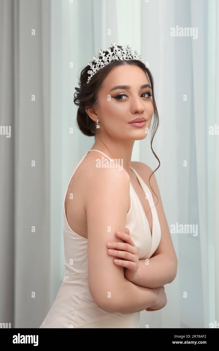 Beautiful young woman wearing luxurious tiara indoors Stock Photo - Alamy