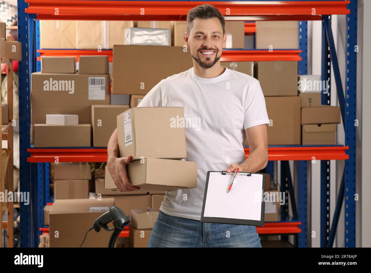 Post office worker with clipboard and parcels near rack indoors Stock ...