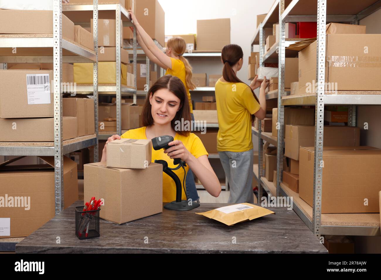 Young post office employees working in warehouse Stock Photo - Alamy