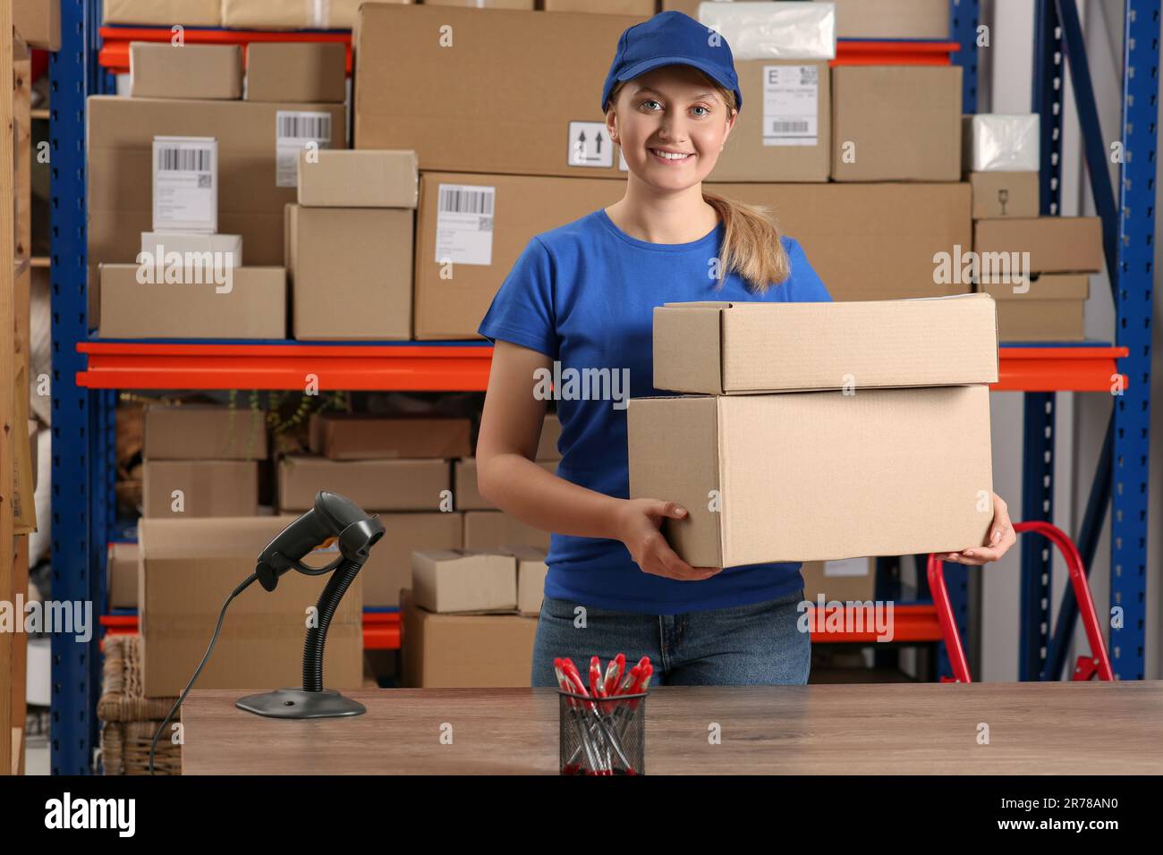 Post office worker with parcels near rack indoors, space for text Stock ...