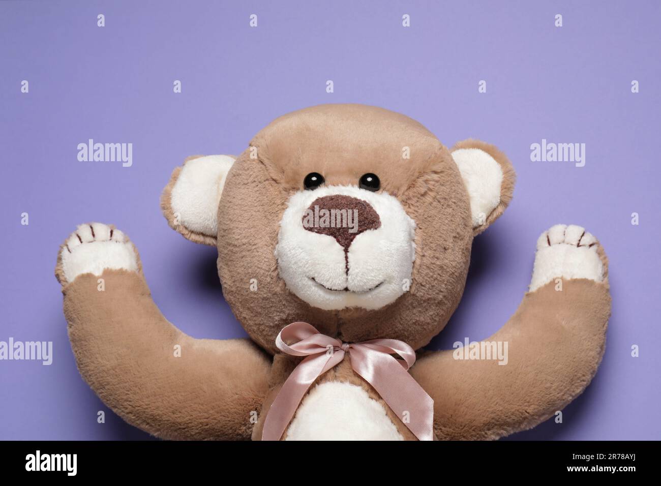 Cute teddy bear on light purple background Stock Photo - Alamy