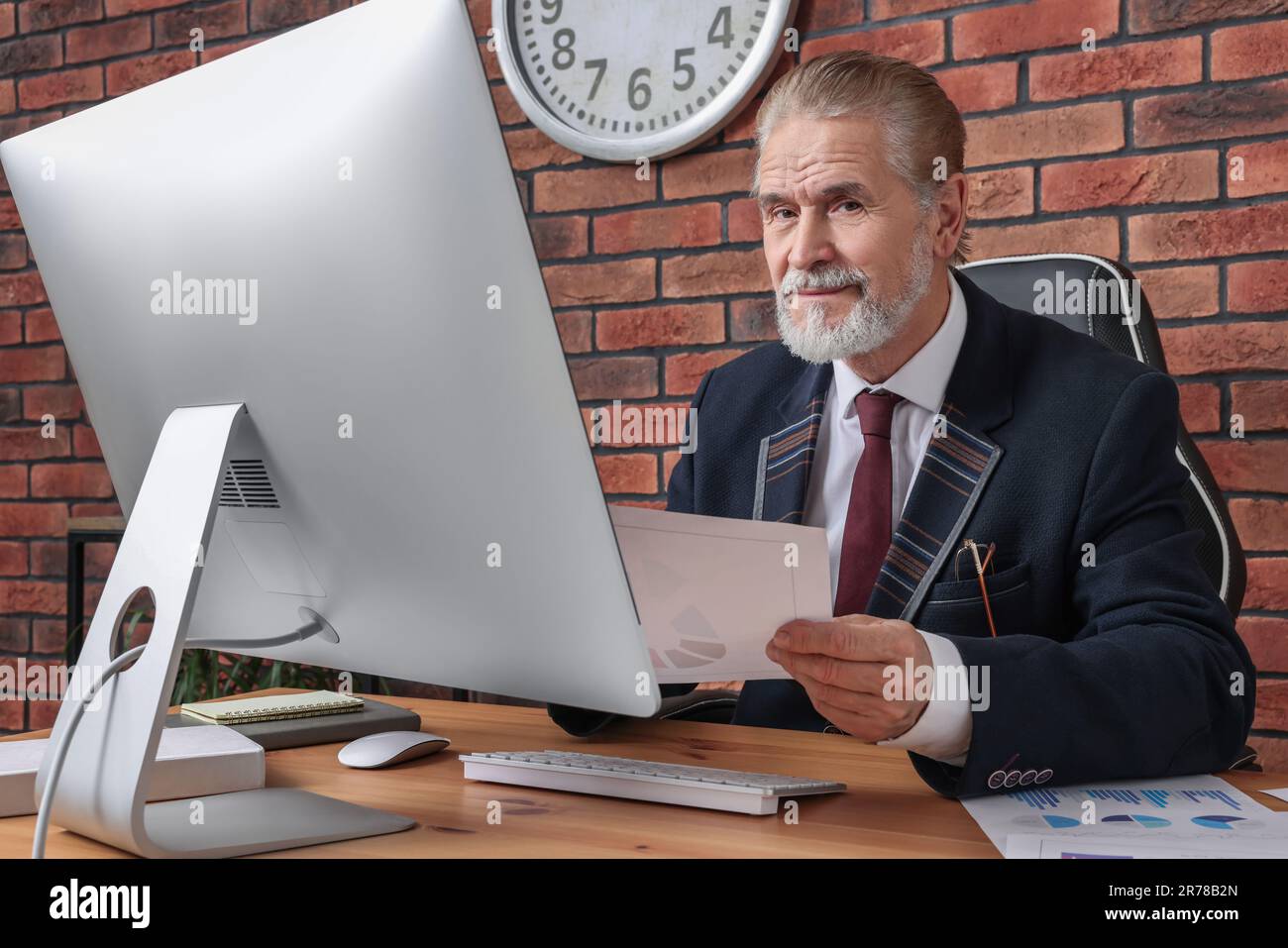 Happy senior boss working in his office Stock Photo - Alamy