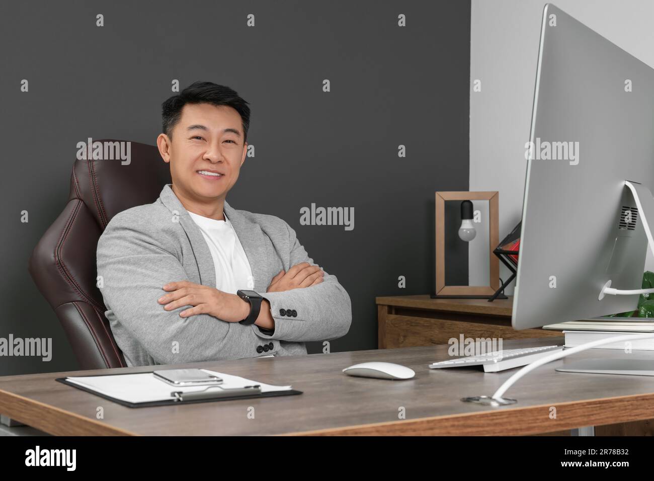 Happy successful boss working in his office Stock Photo - Alamy