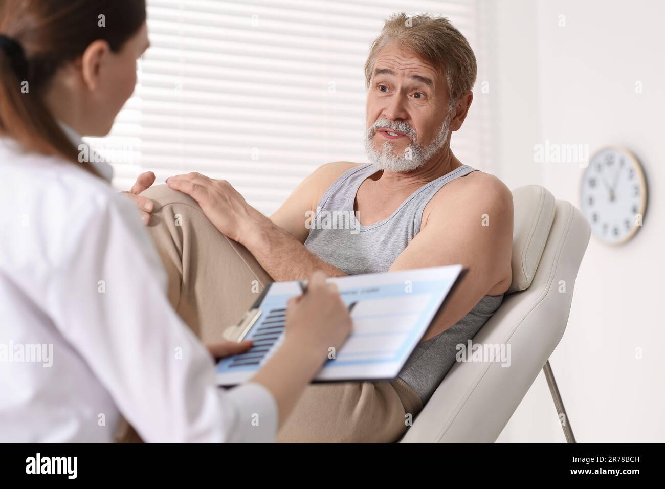 Doctor filling form senior woman hi-res stock photography and images ...