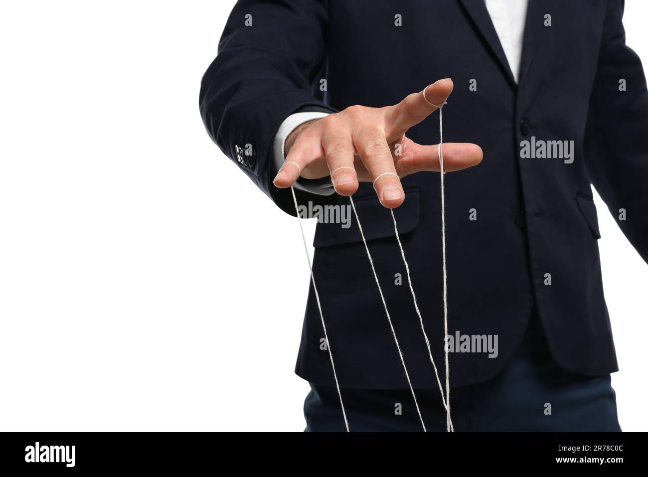 Man in suit pulling strings of puppet on white background, closeup ...