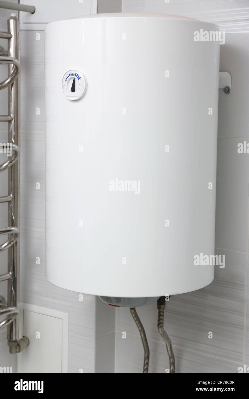 White boiler with temperature control indicator indoors Stock Photo - Alamy