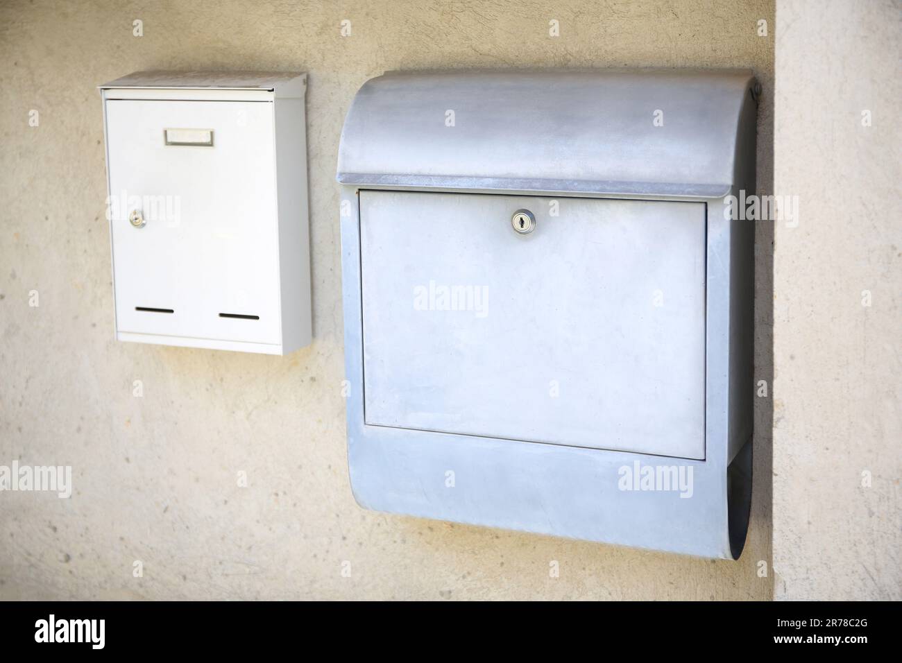 White metal letter boxes on beige wall Stock Photo - Alamy
