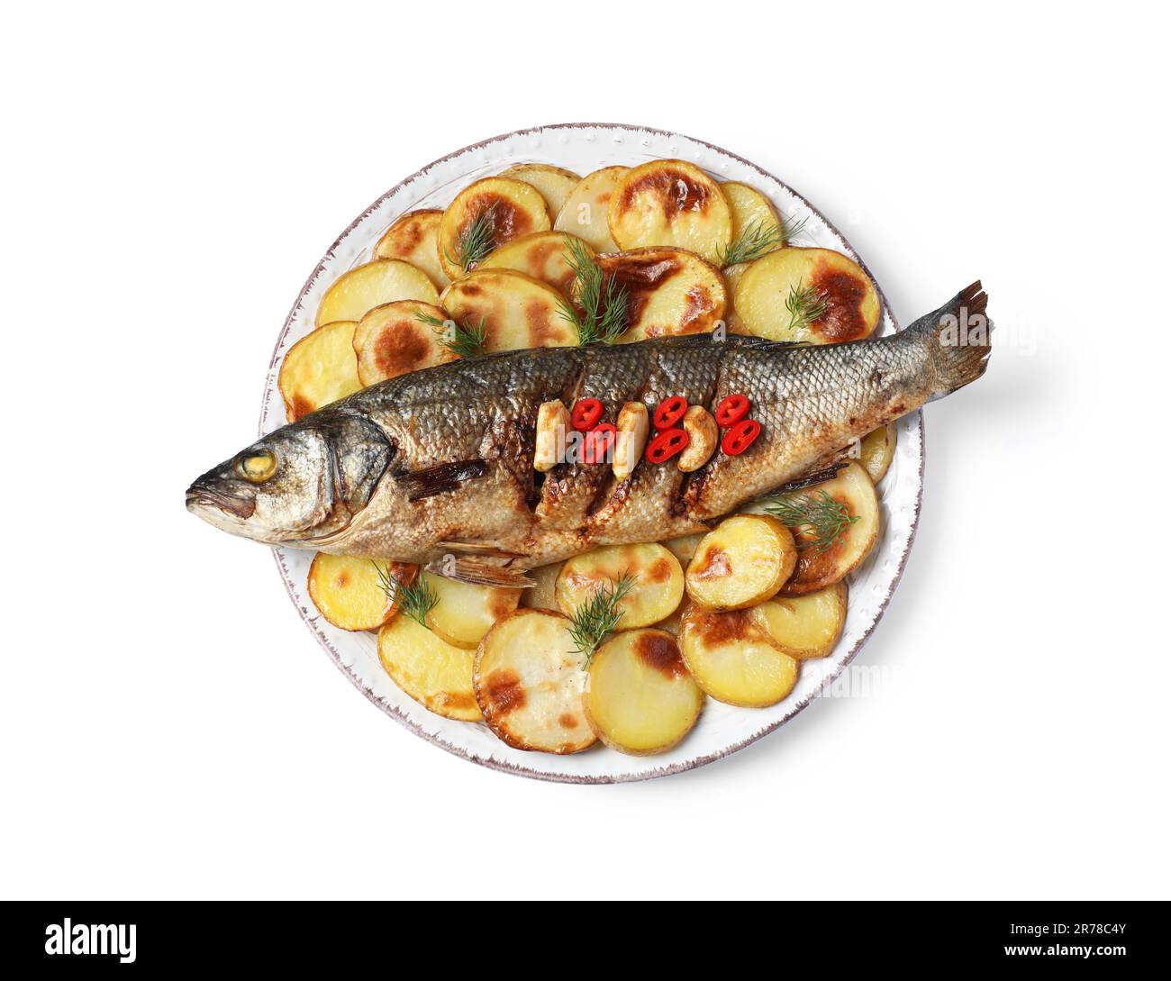 Plate with delicious roasted sea bass fish and potatoes on white ...