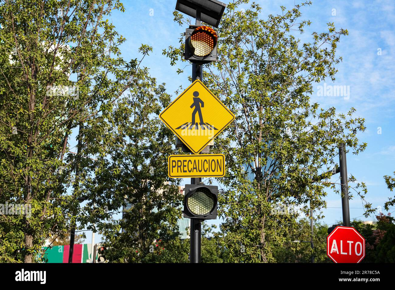 Different road signs and traffic lights on city street Stock Photo - Alamy