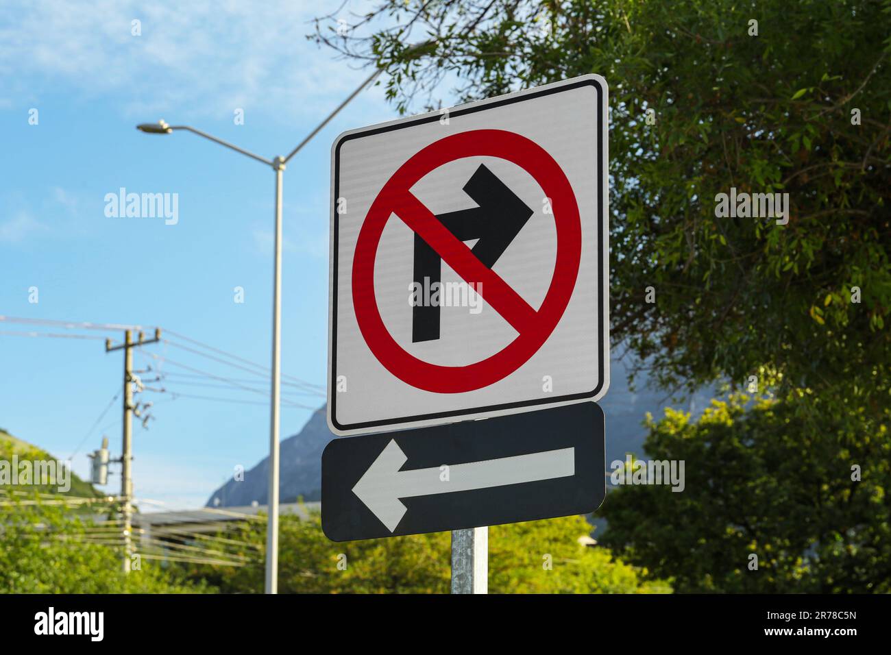 Different road signs on city street against blue sky Stock Photo - Alamy
