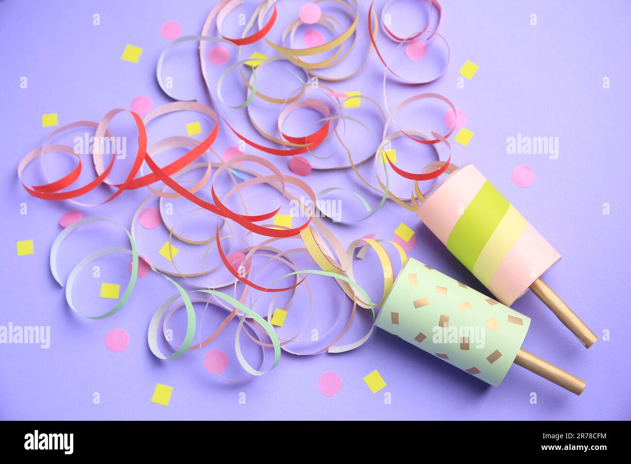 Beautiful serpentine and confetti bursting out of party poppers on ...