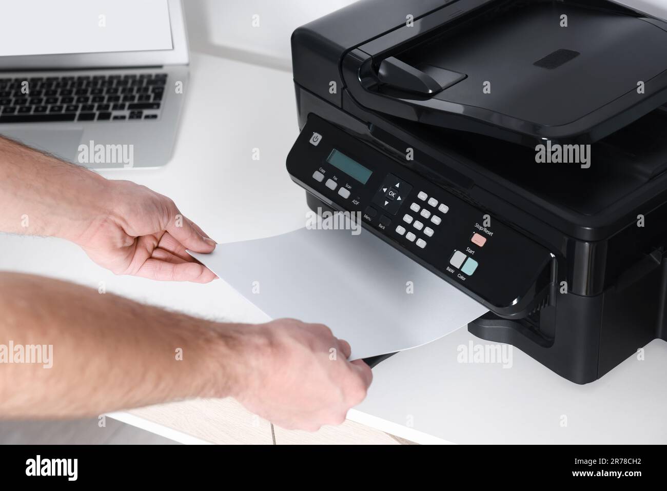 Man using modern printer at white desk in office, closeup Stock Photo - Alamy