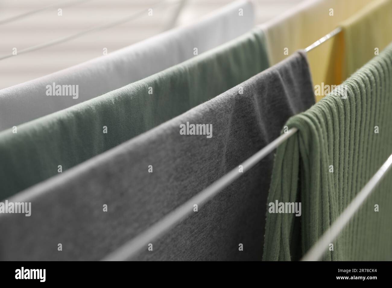 Different apparel drying on clothes airer, closeup Stock Photo - Alamy
