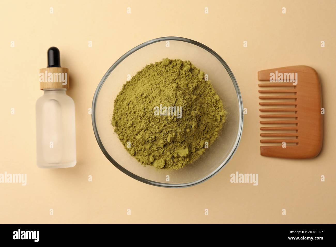 Henna powder, bottle of liquid and comb on beige background, flat lay ...