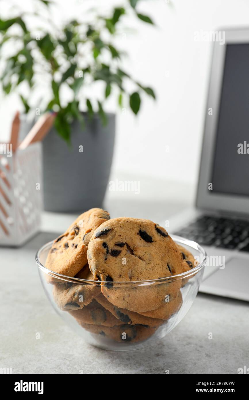Chocolate chip cookies on light gray table at workplace Stock Photo - Alamy