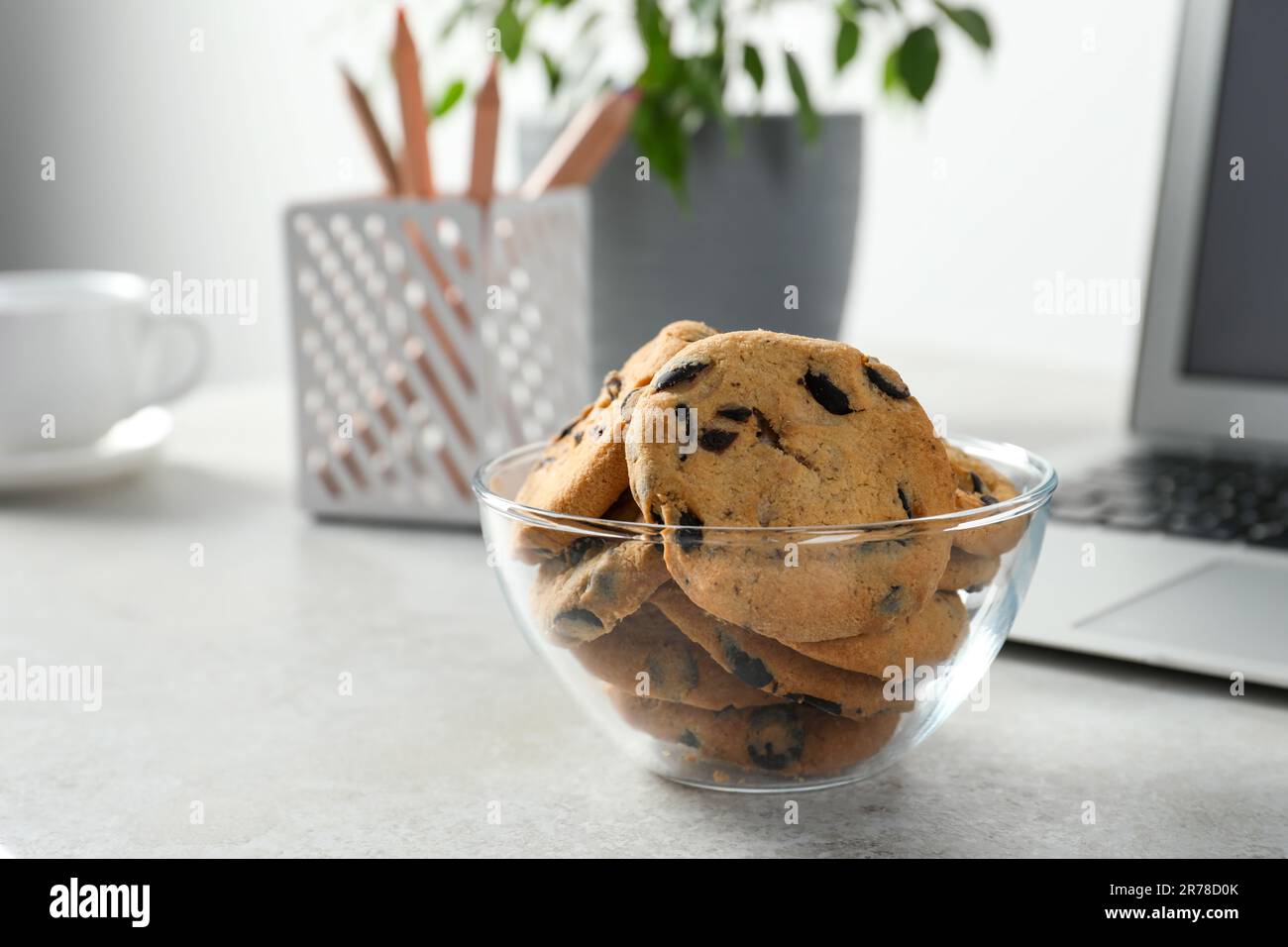 Chocolate chip cookies on light gray table at workplace Stock Photo - Alamy