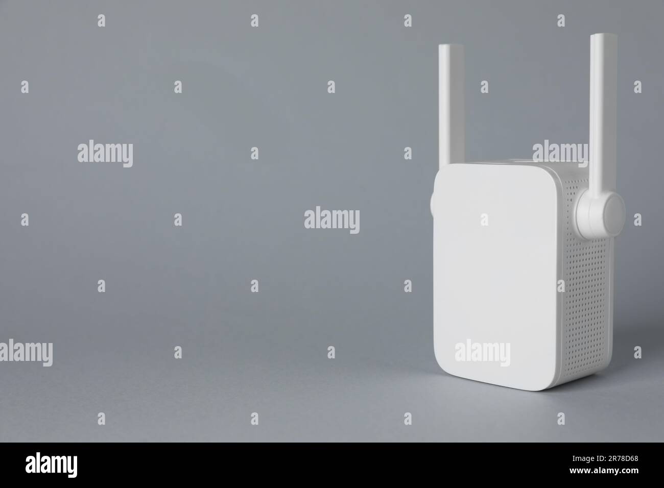 New modern Wi-Fi repeater on light gray background, space for text ...