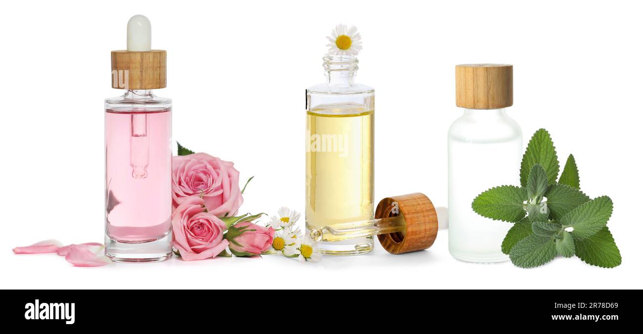 Many different essential oils and ingredients on white background ...