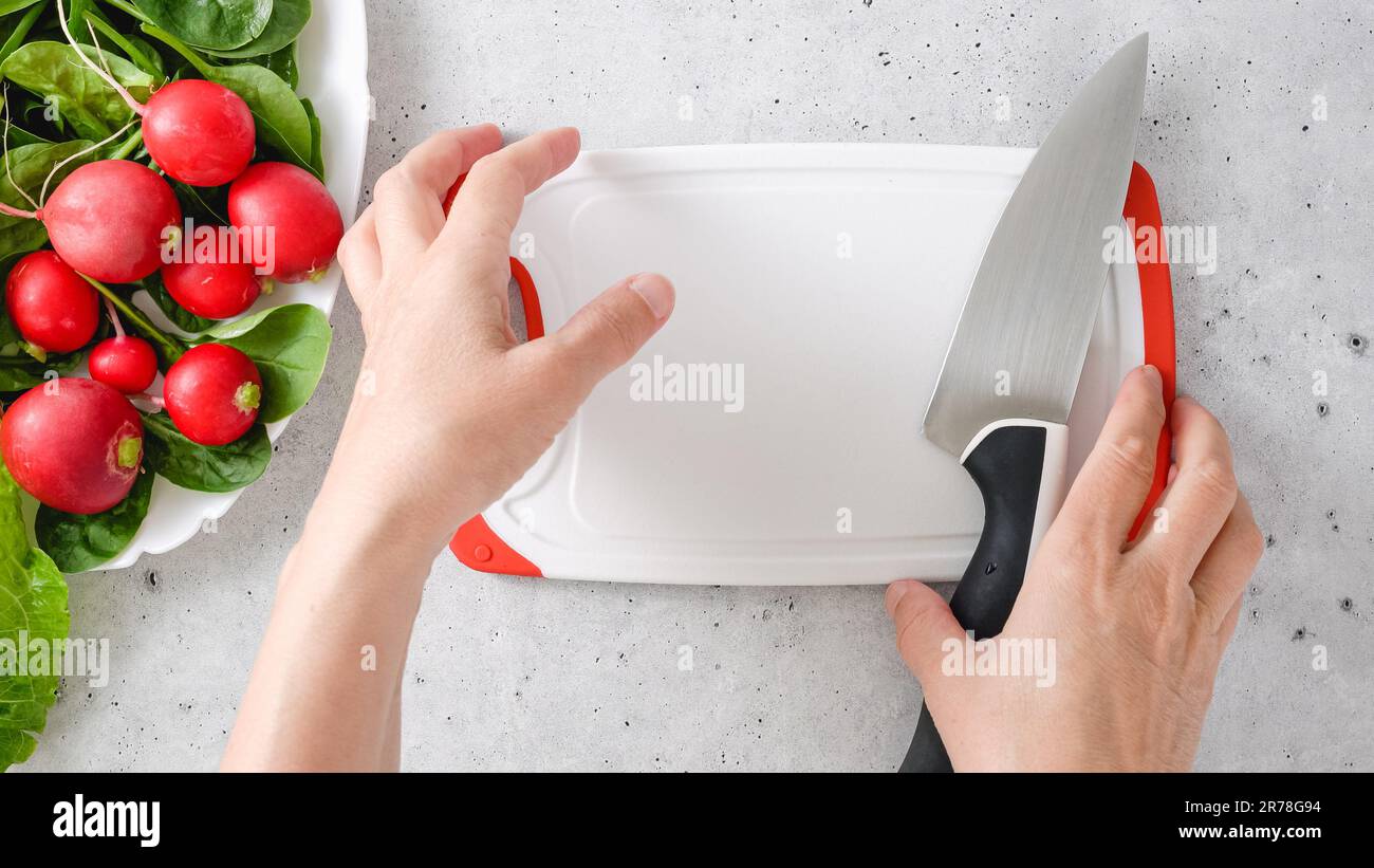 Lettuce, spinach, and radish salad recipe. Woman making salad, close-up ...