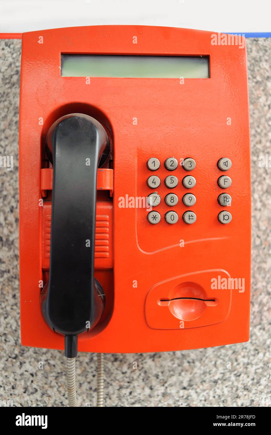 Red payphone on the wall Stock Photo - Alamy