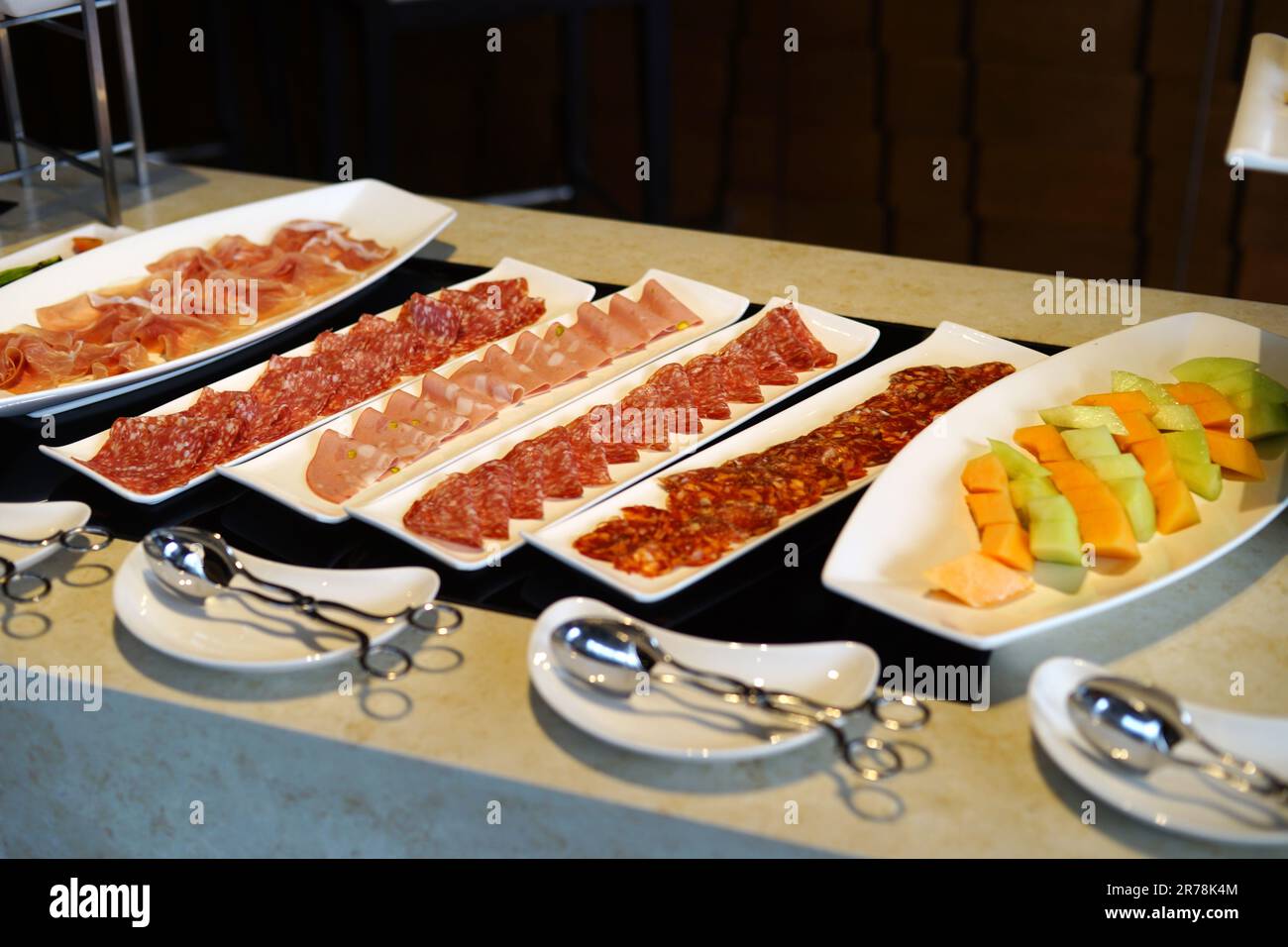 Fresh cold cuts on the long plates in restaurant Stock Photo - Alamy