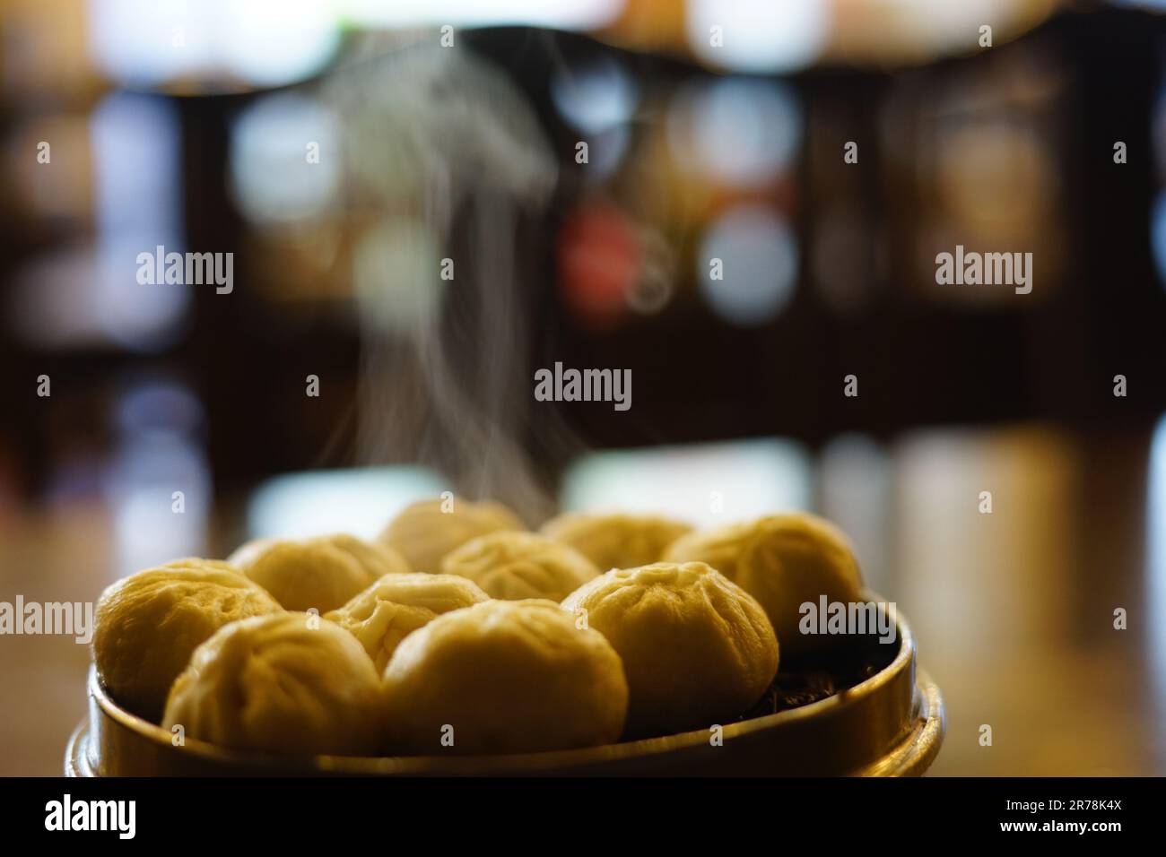 Chinese dumplings being steamed on the traditional bamboo pan Stock ...