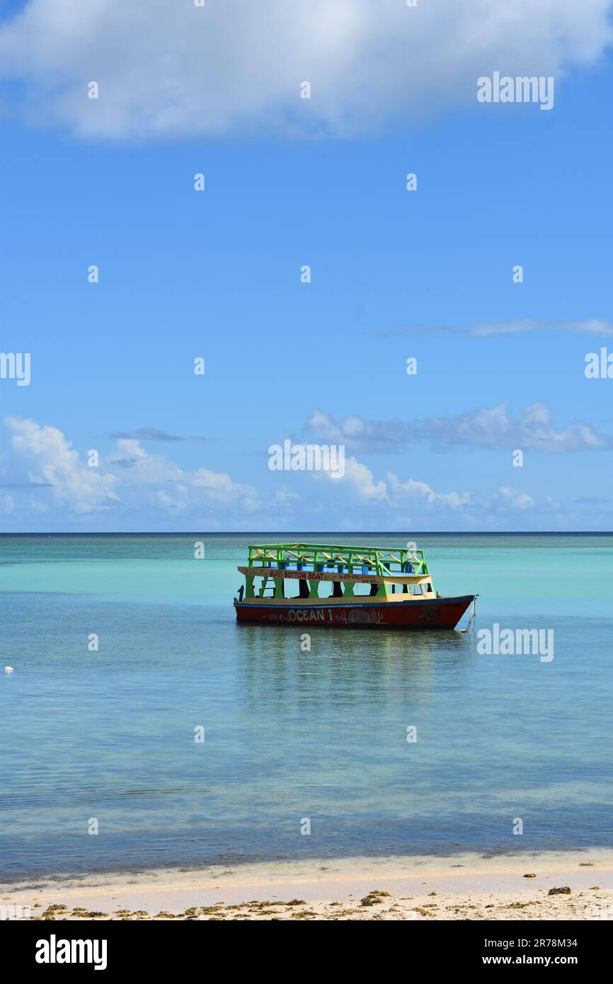 Glass bottom boats in Pigeon Point carrying tourists on tours to see the Buccoo Reef, Nylon Pool ...