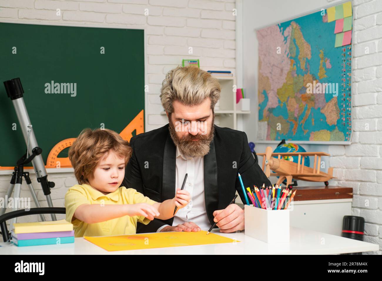 Little boy pupil with happy face expression near desk with school ...