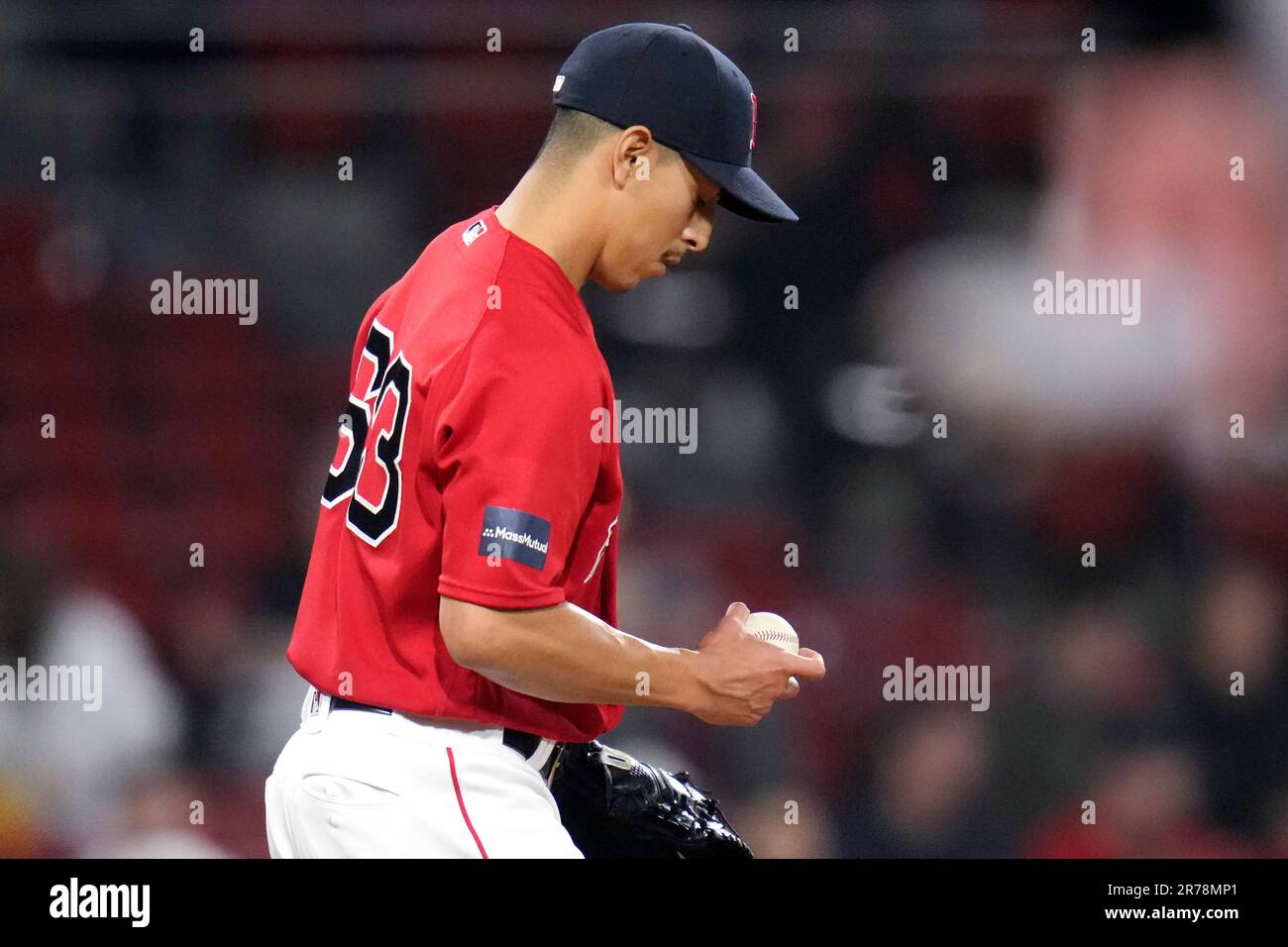 Boston Red Sox pitcher Justin Garza looks down at the ball in the tenth ...