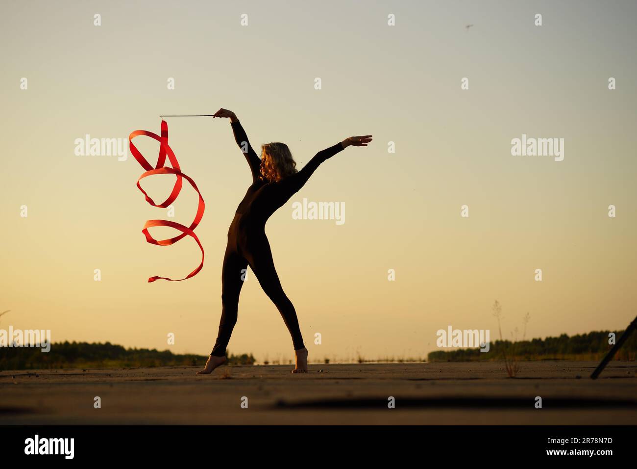 Professional gymnast woman dancer posing with ribbon Stock Photo - Alamy