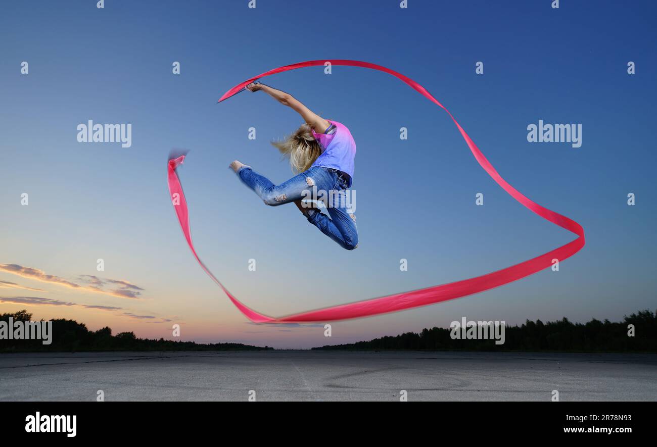 Professional gymnast woman dancer jumping with ribbon Stock Photo - Alamy