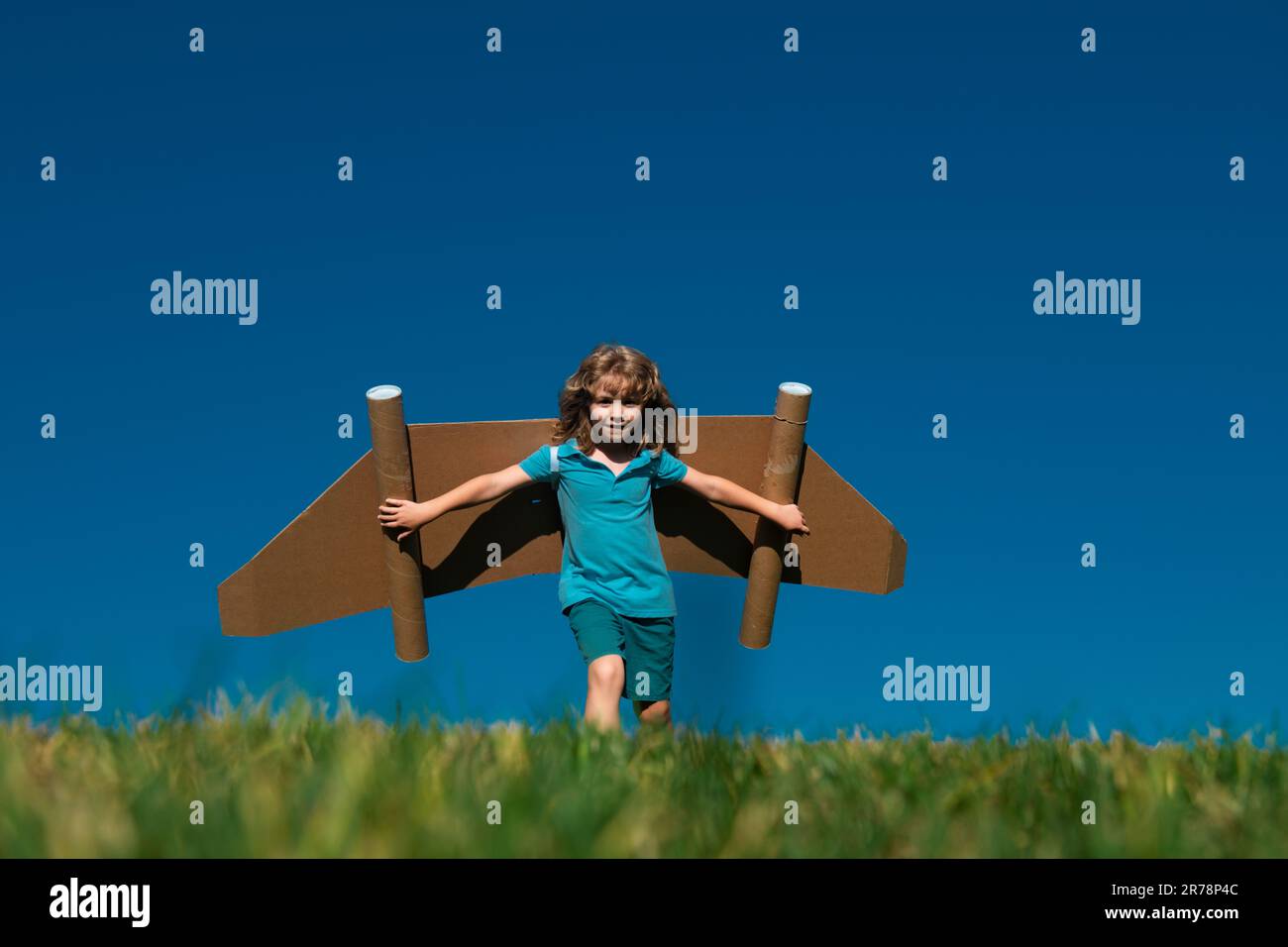 Kid with jet pack superhero. Child pilot against summer sky background ...