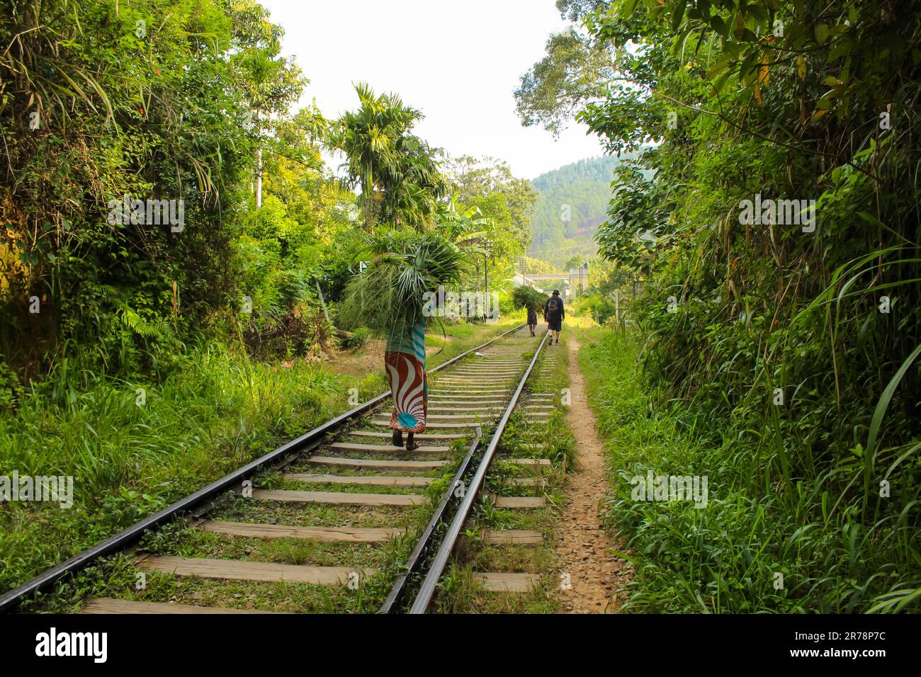 Locals going through The main line railroad at Ella, Sri Lanka. The ...