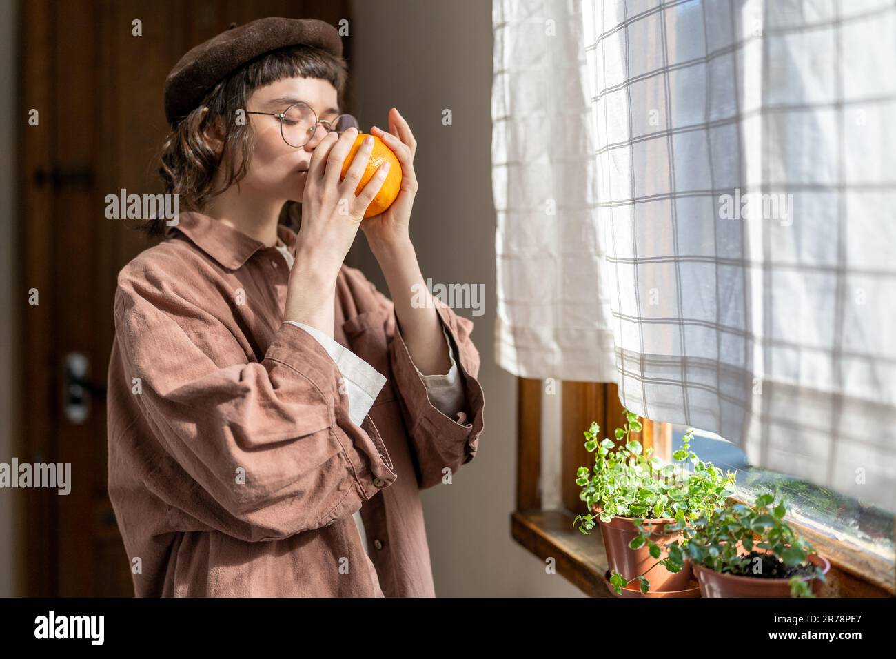 Woman smelling orange fruit hi-res stock photography and images - Alamy
