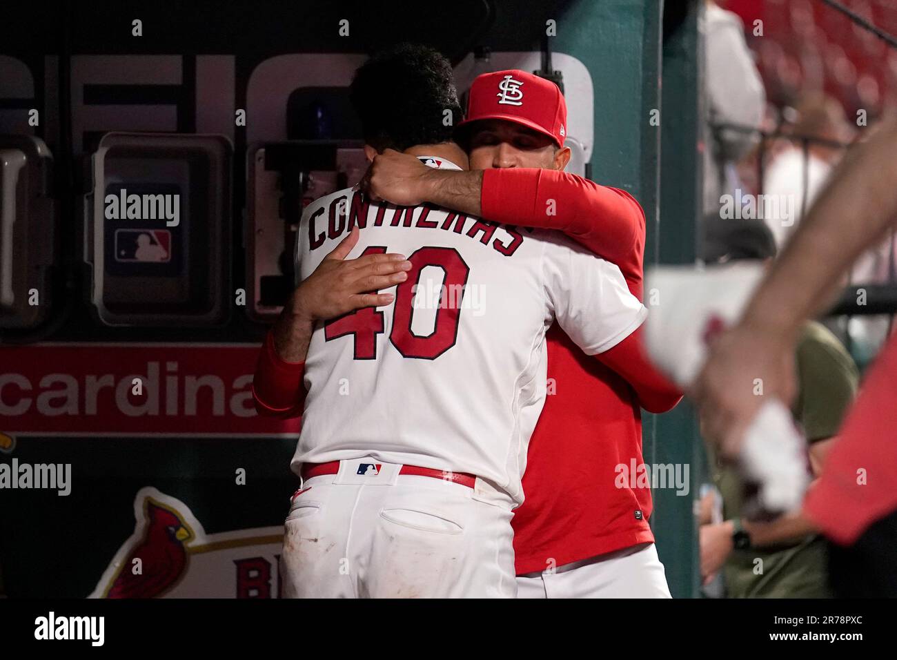 St. Louis Cardinals catcher Willson Contreras, left, gets a hug from ...