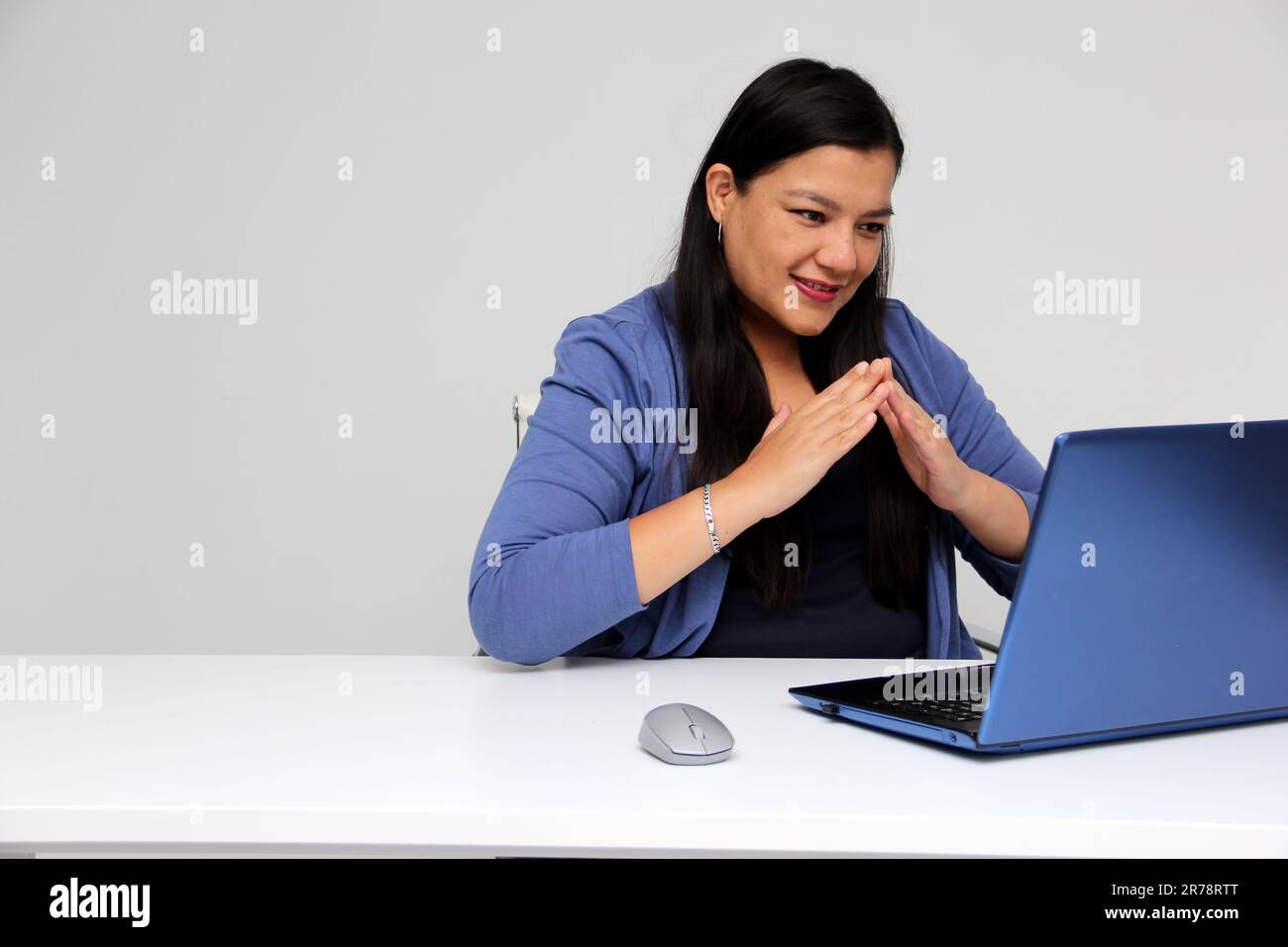 Latino adult woman speaks Mexican sign language with a deaf person ...