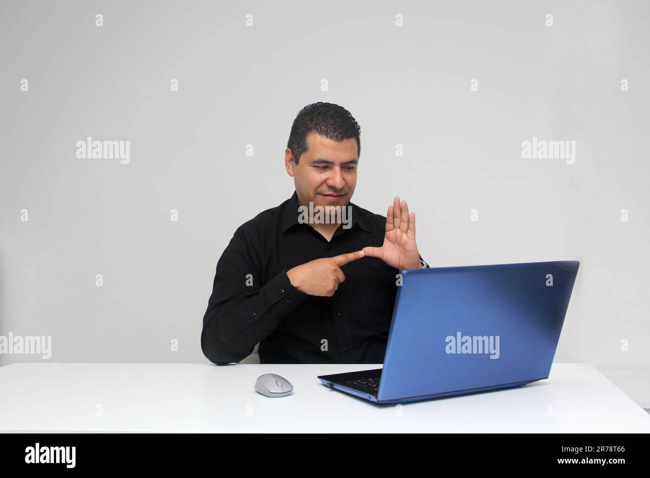 Latino adult man speaks Mexican sign language with a deaf person ...