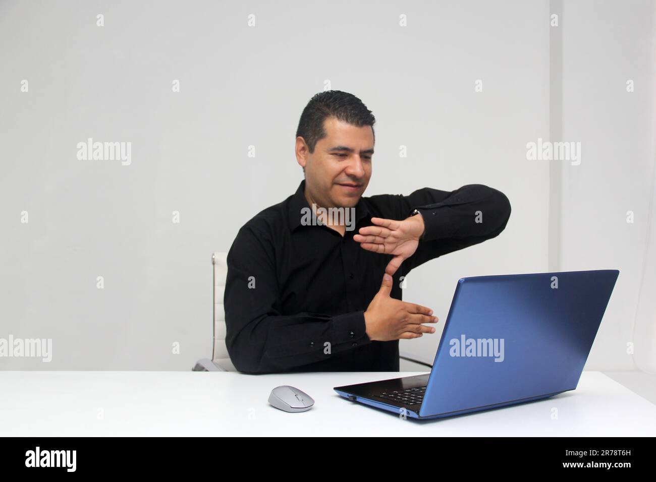 Latino adult man speaks Mexican sign language with a deaf person ...