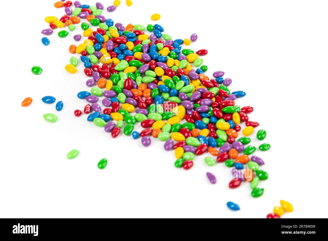 Scatter of candy coated sunflower seeds isolated over white top down ...
