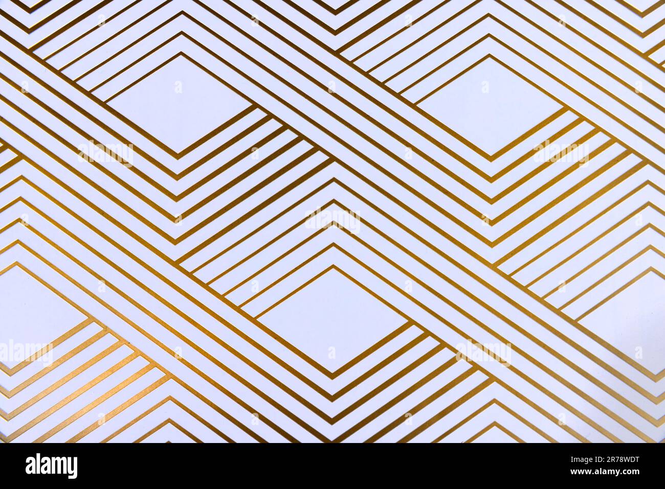 Shiny gold geometric lines on white paper top down view Stock Photo - Alamy